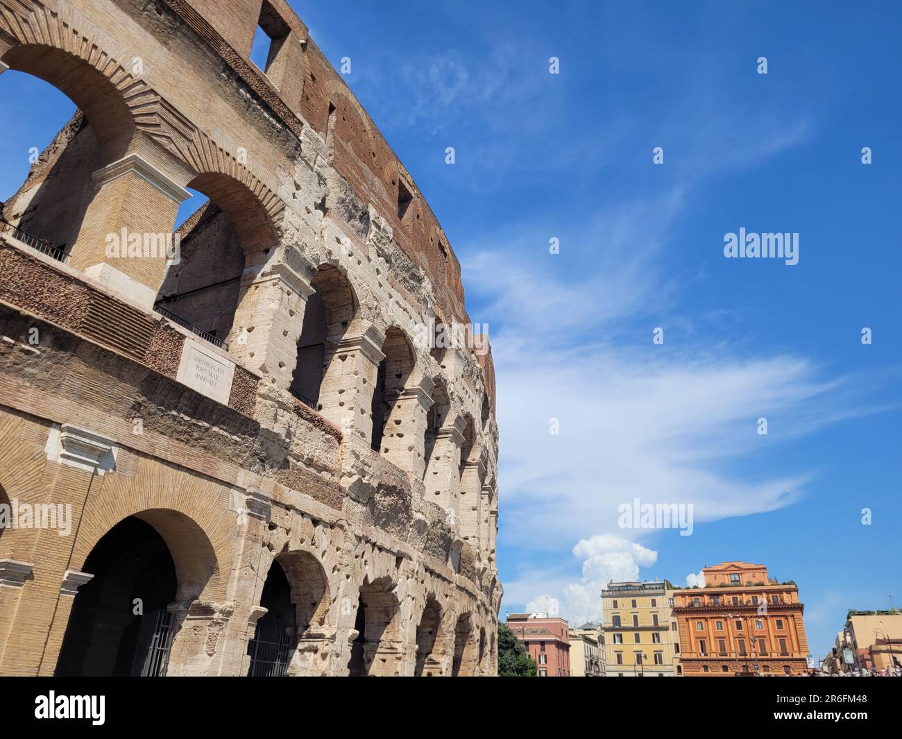 the majestic Colosseum in Rome, Italy, illuminated by the bright blue ...
