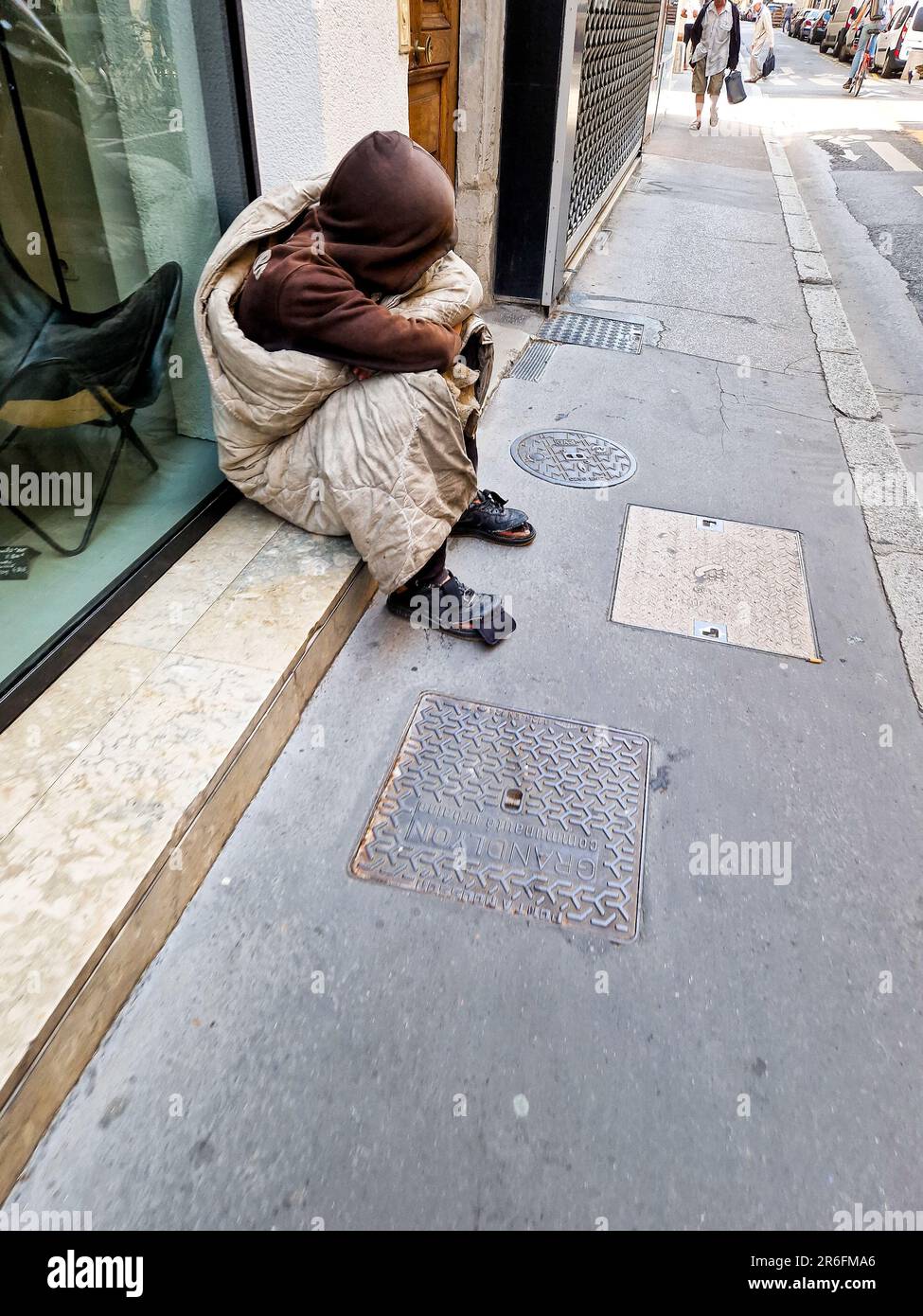 Homeless sitting on the sidewalk, Lyon, France Stock Photo - Alamy