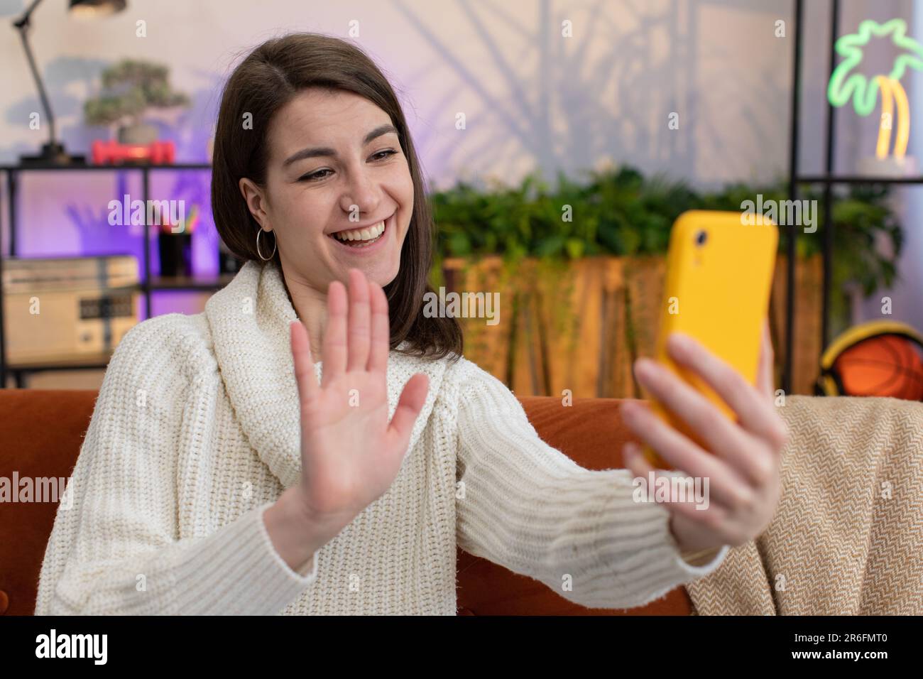 Young woman making online selfie video call talking waving hand hello ...