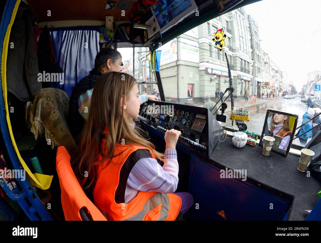 Woman streetcar driver and a little girl sitting at workplace in driver ...
