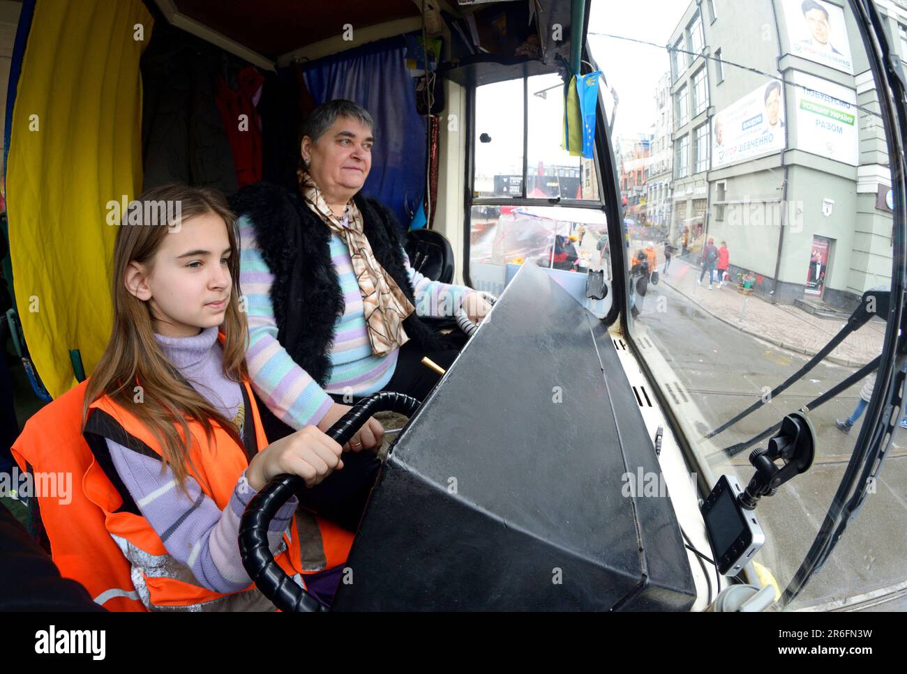 Woman streetcar driver and a little girl sitting at workplace in driver ...