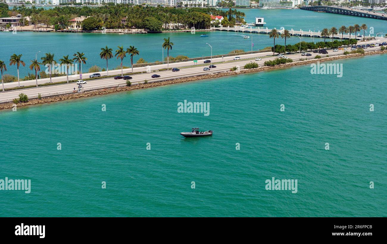 A beautiful boat is docked in the still waters of a serene harbor ...