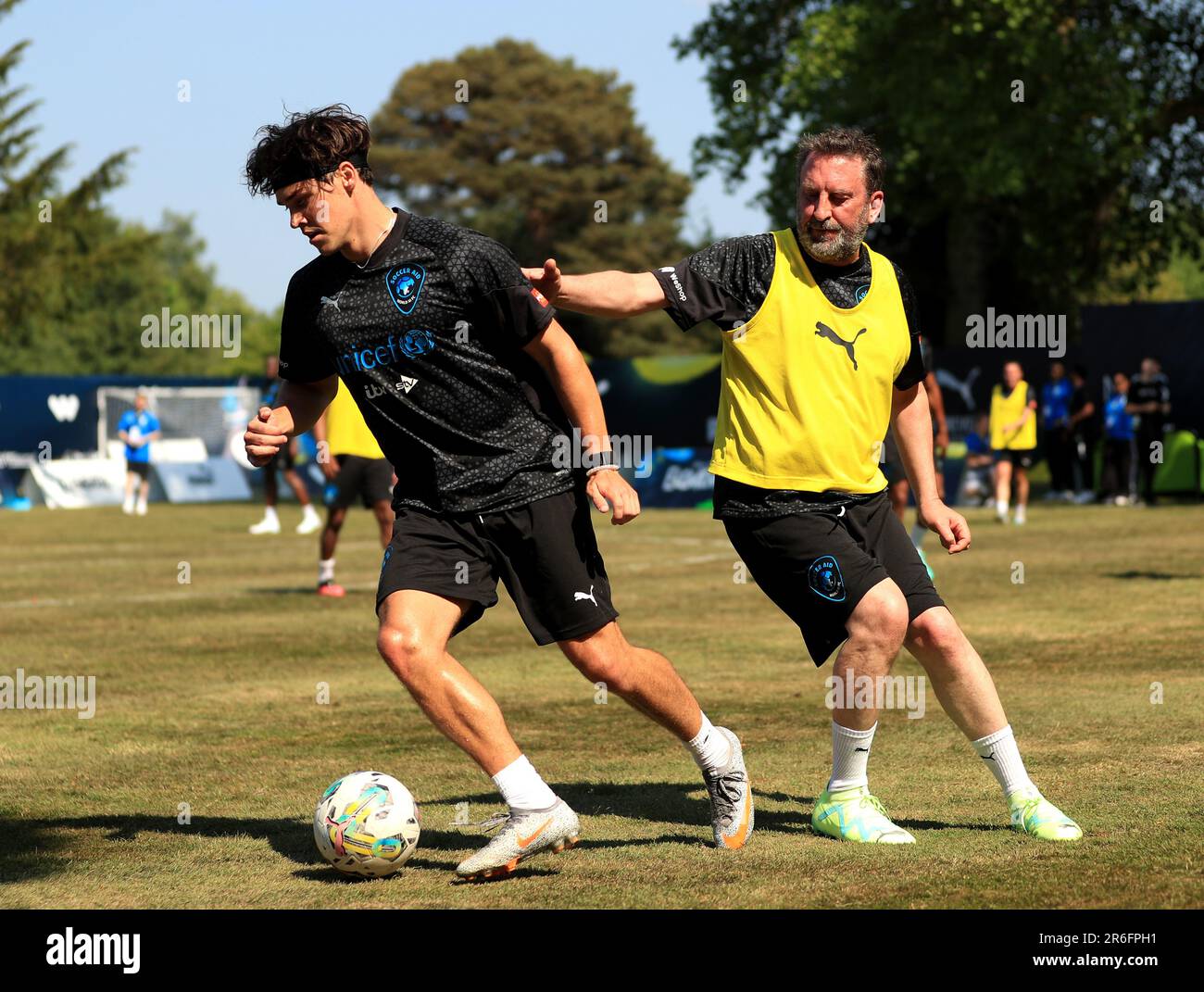Noah Beck and Lee Mack battle for the ball during a training session at ...