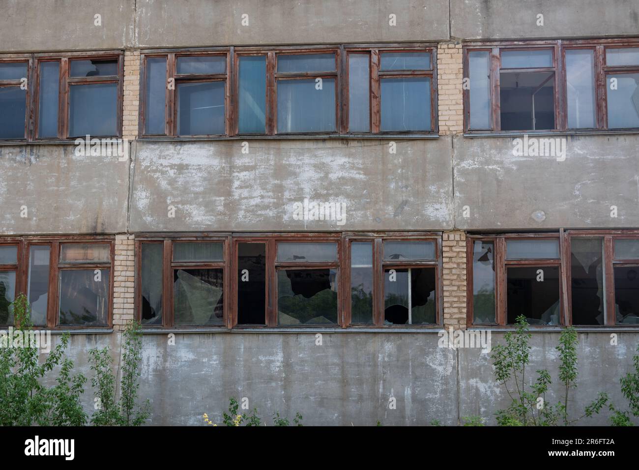 Broken windows in the facade of an old building after an accident ...