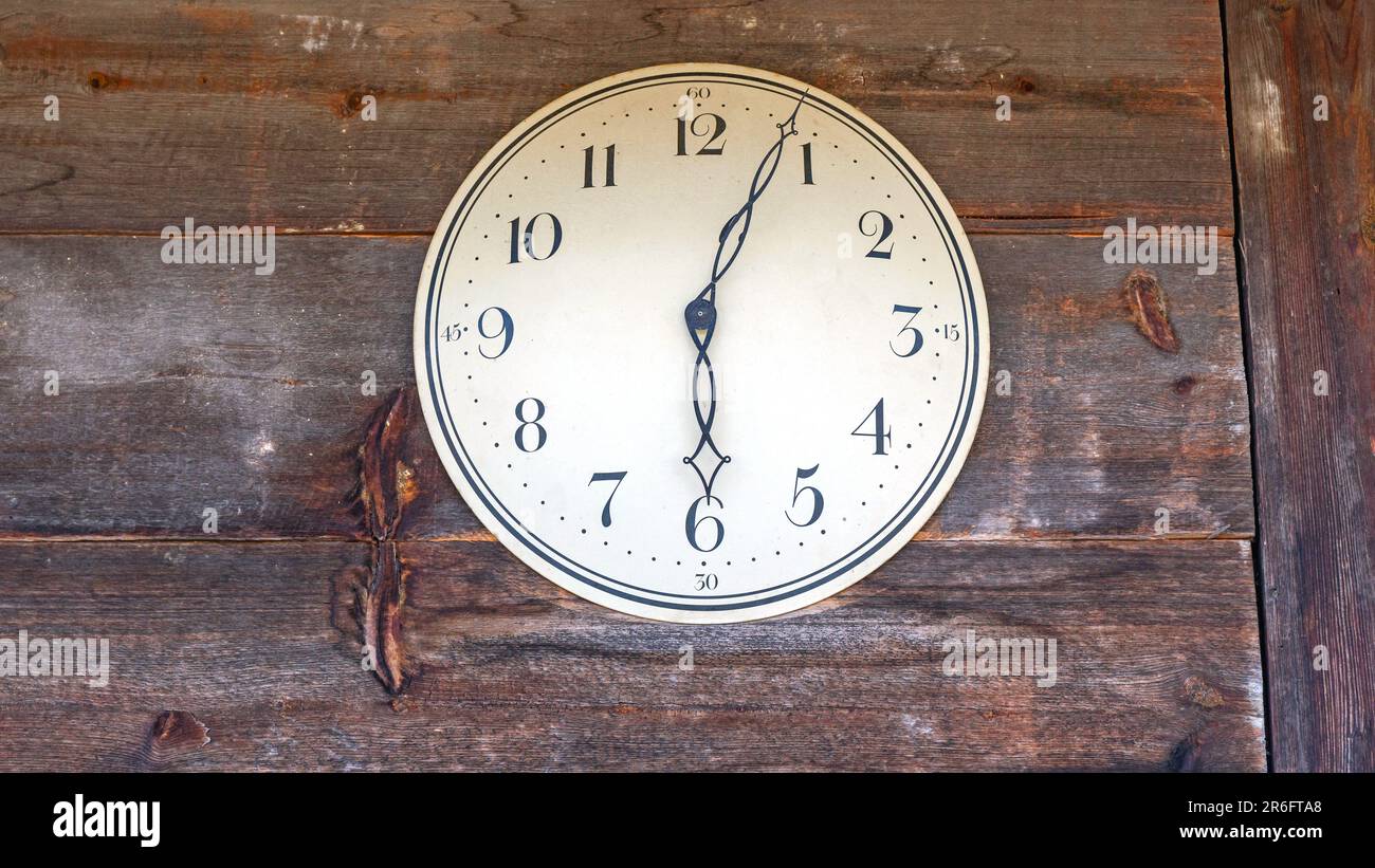 White Clock With Numbers at Wooden Cabin Wall Stock Photo - Alamy