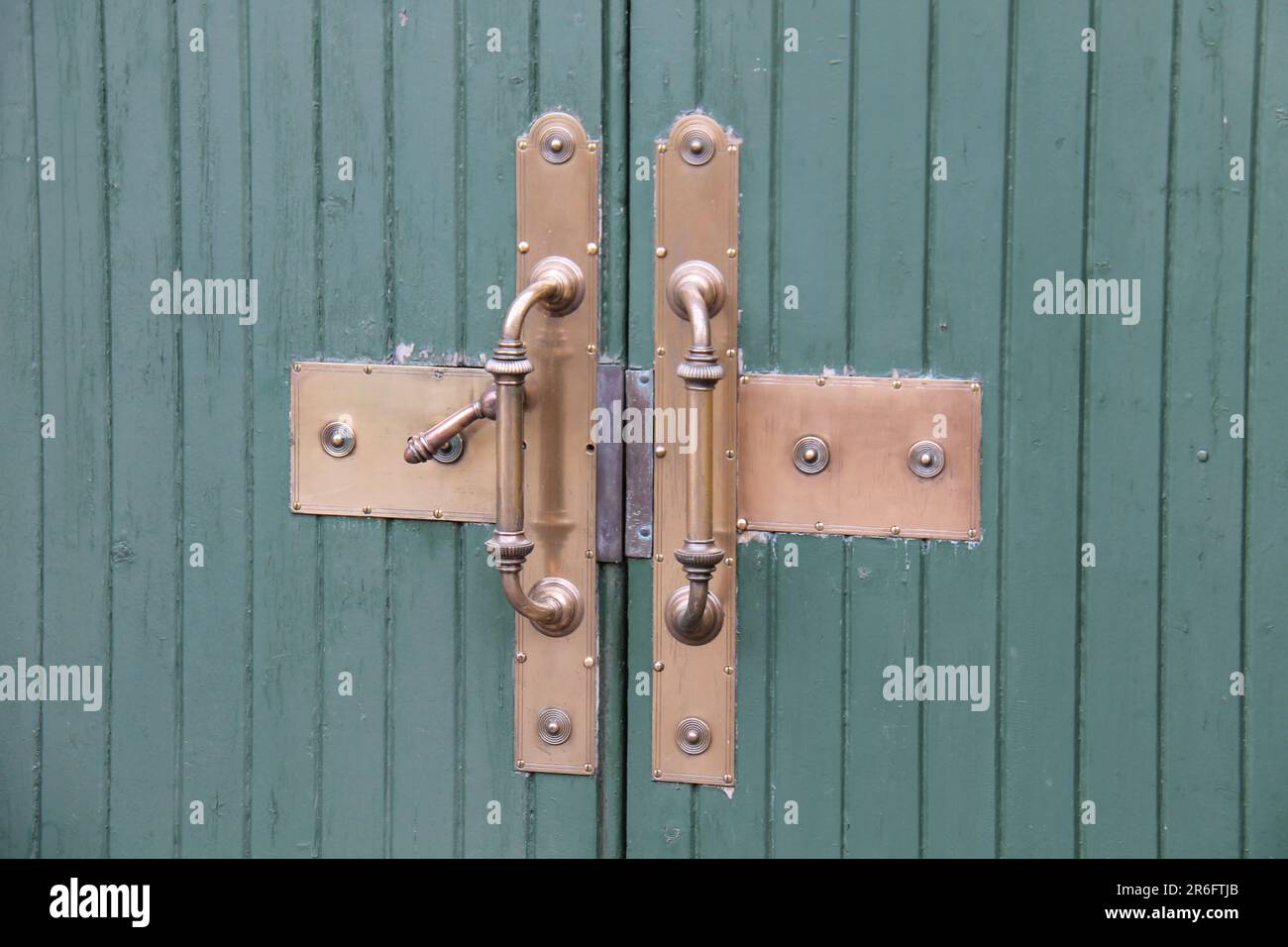 The Large Copper Door Handles of a Wooden Doorway Stock Photo - Alamy