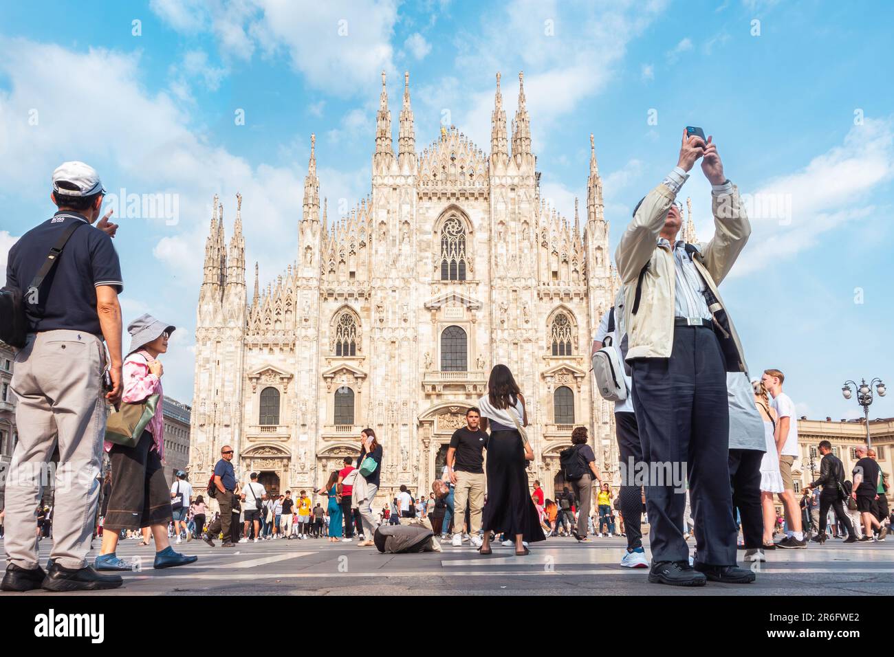 Milan Piazza Duomo Cathedral, tourists taking photos. Crowd of people ...