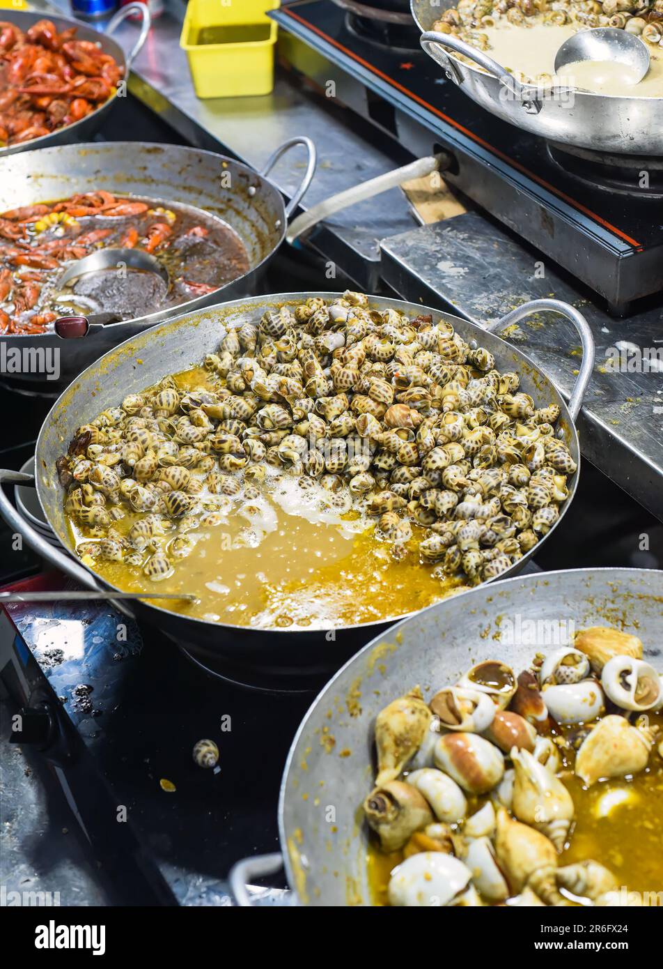 Vietnamese stewed seashells in sauce in the night market on food ...