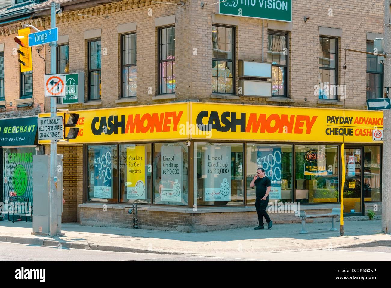 Toronto, Canada - June 4, 2023: A man walking on a sidewalk alongside a ...