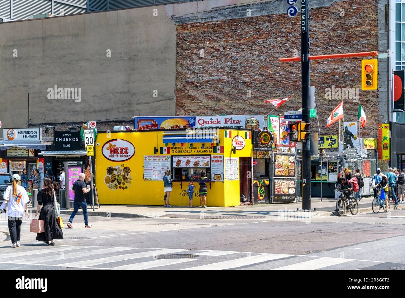Toronto, Canada - June 4, 2023: Pedestrians and cyclists on a downtown ...