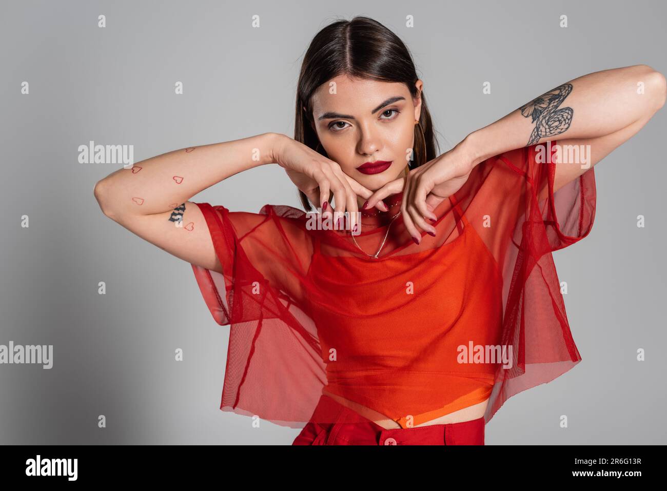 generation z, portrait of tattooed and brunette young woman with short ...