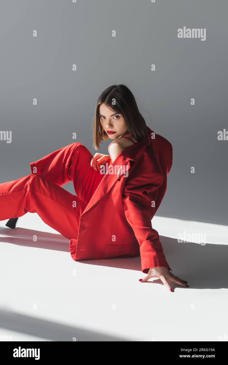 fashionista, young brunette woman with short hair posing in suit on ...