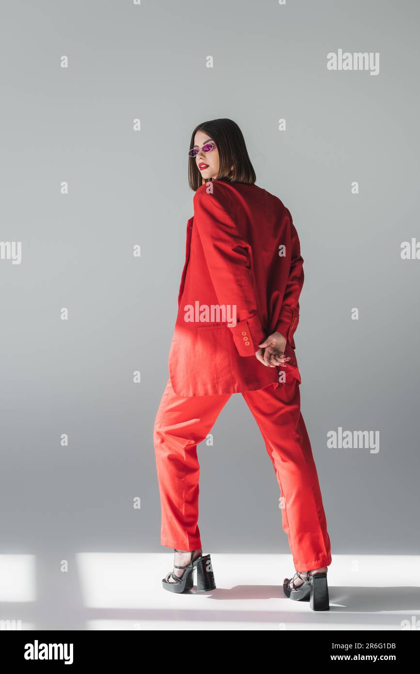 lady in red, young brunette woman with short hair posing in pink ...