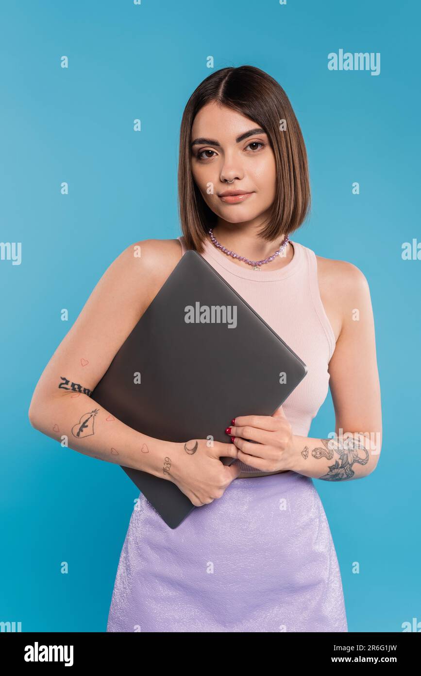 freelancer, brunette young woman with short hair, tattoos and nose ...