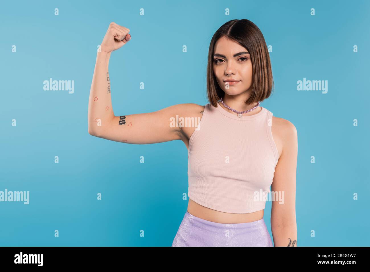 female power, brunette young woman with short hair, tattoos and nose ...