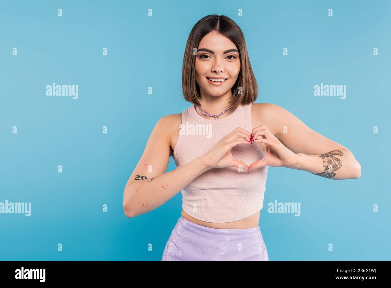 positivity and love, happy young woman with short hair, tattoos and ...