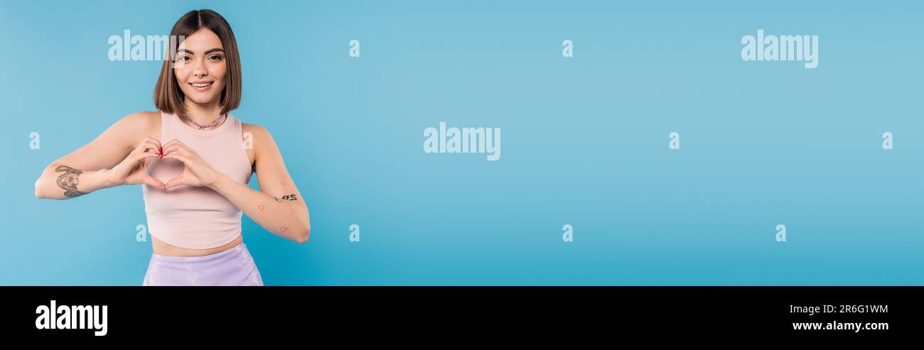 positivity and love, happy young woman with short hair, tattoos and ...