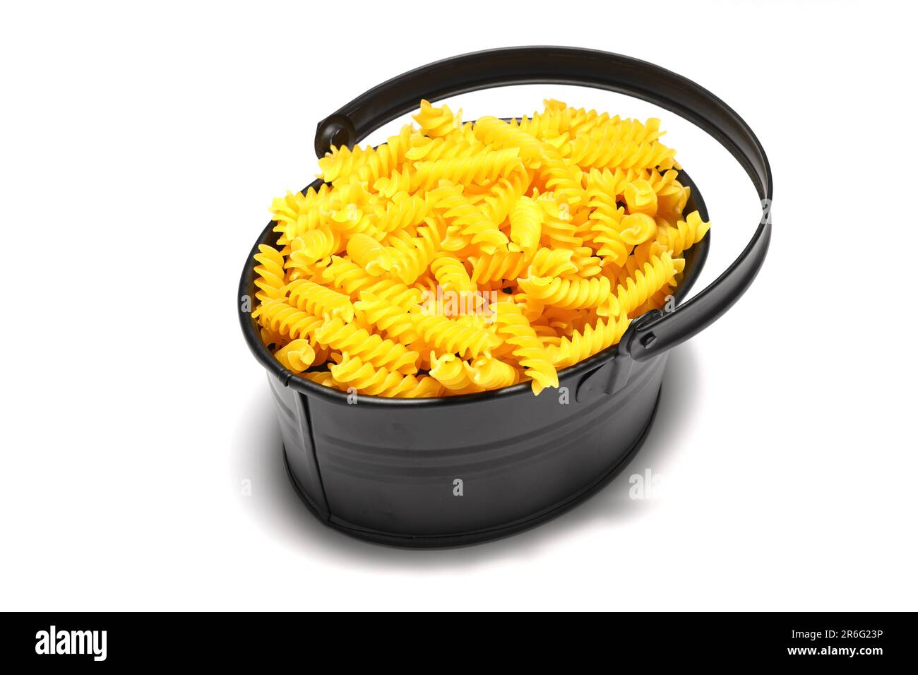 pile of spiral pasta scattered on light background. corkscrew shaped ...