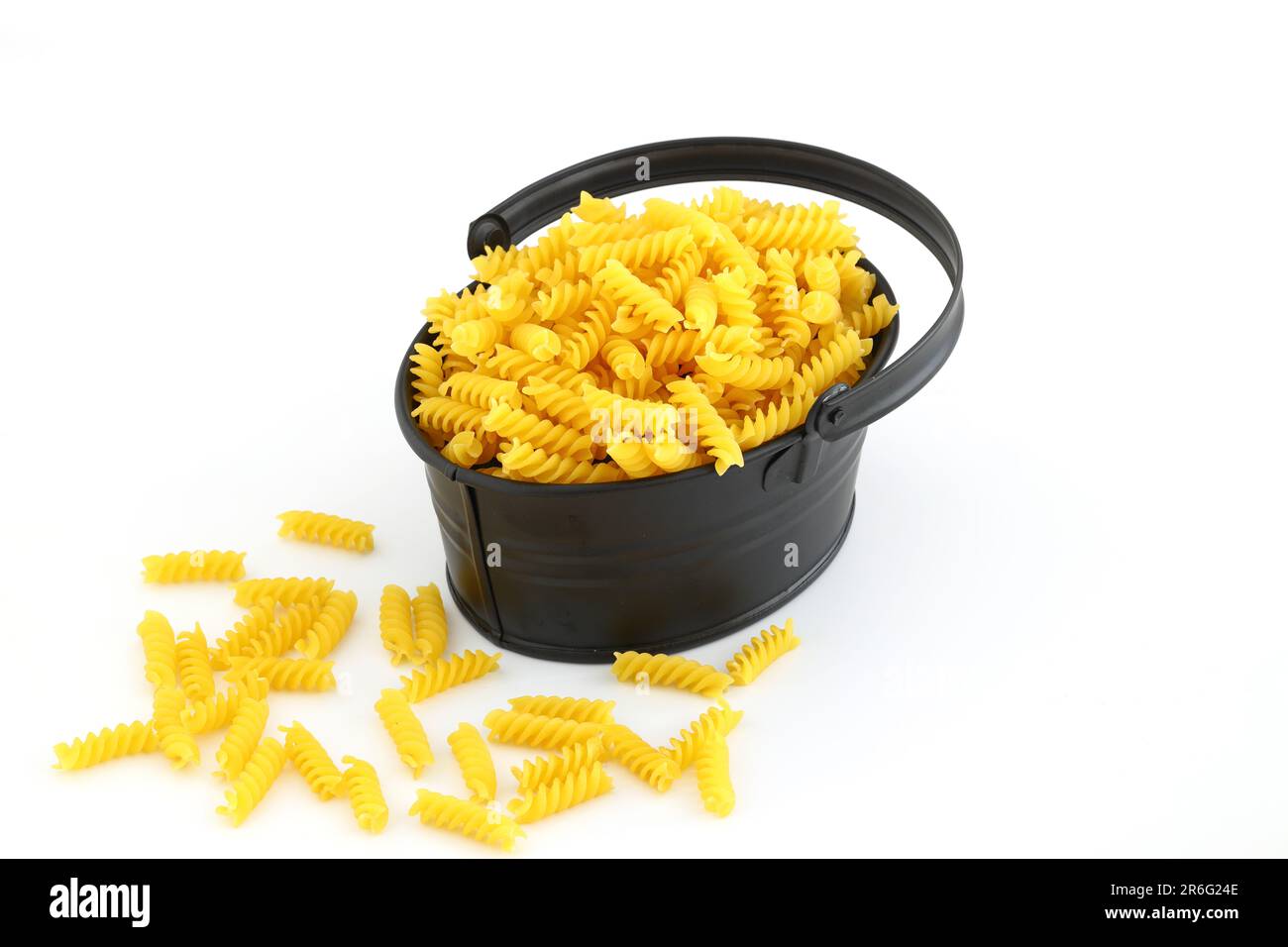 pile of spiral pasta scattered on light background. corkscrew shaped ...