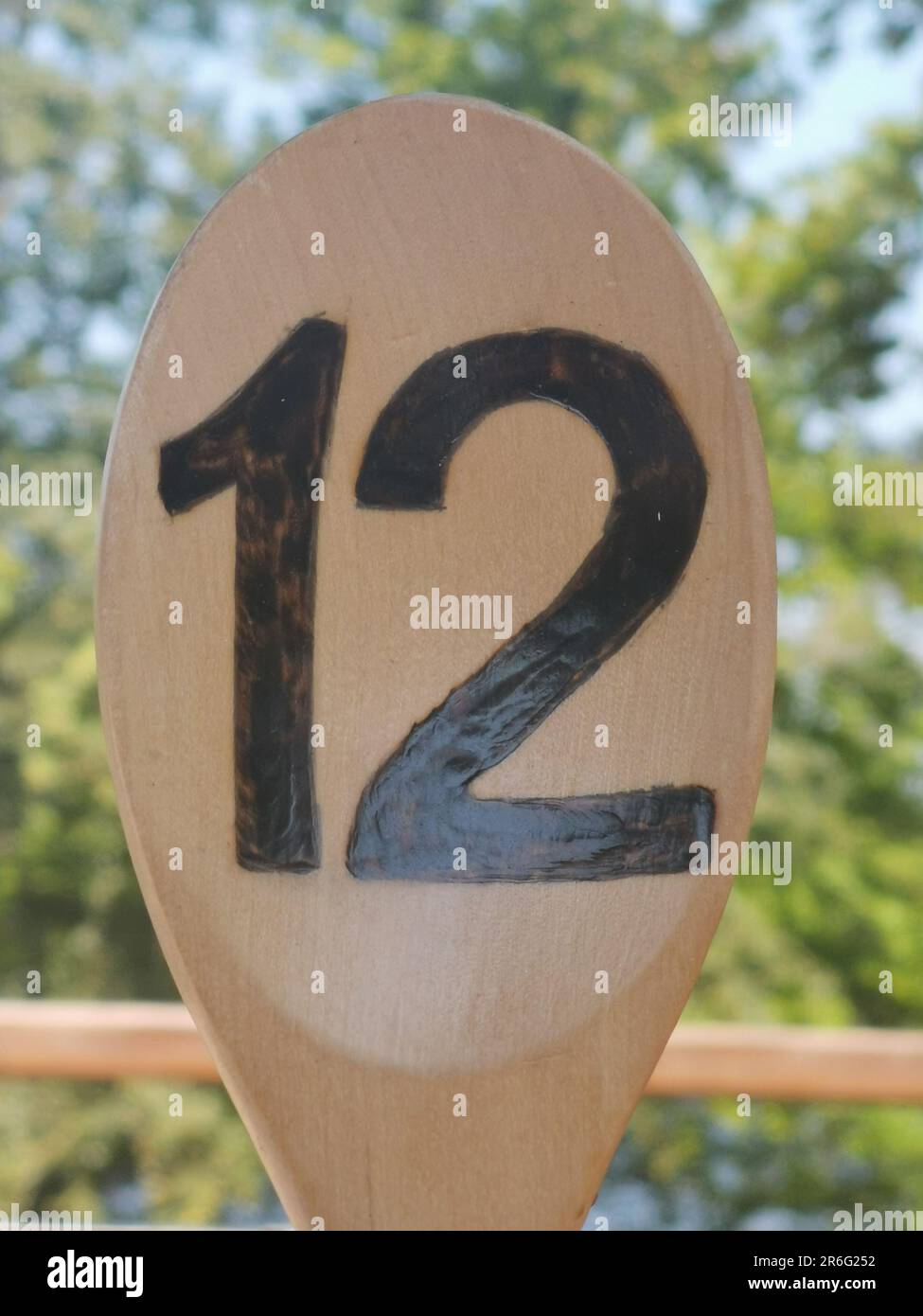 Wooden spoon bearing the number twelve painted in black with copy space ...