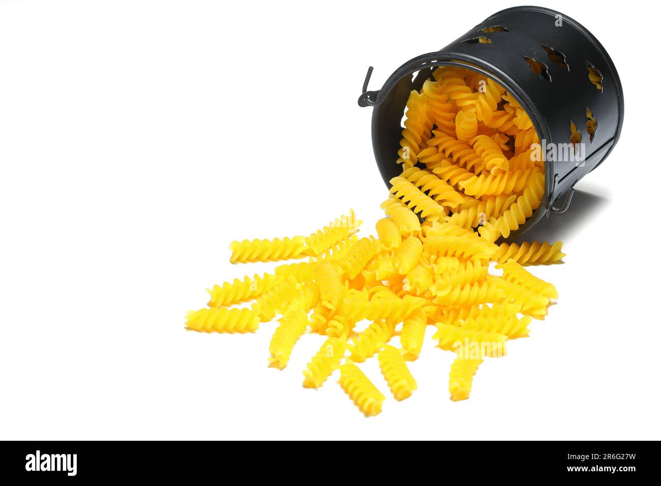 pile of spiral pasta scattered on light background. corkscrew shaped ...