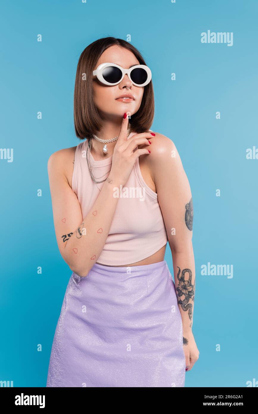 fashion trend, brunette young woman with short hair in tank top, skirt ...