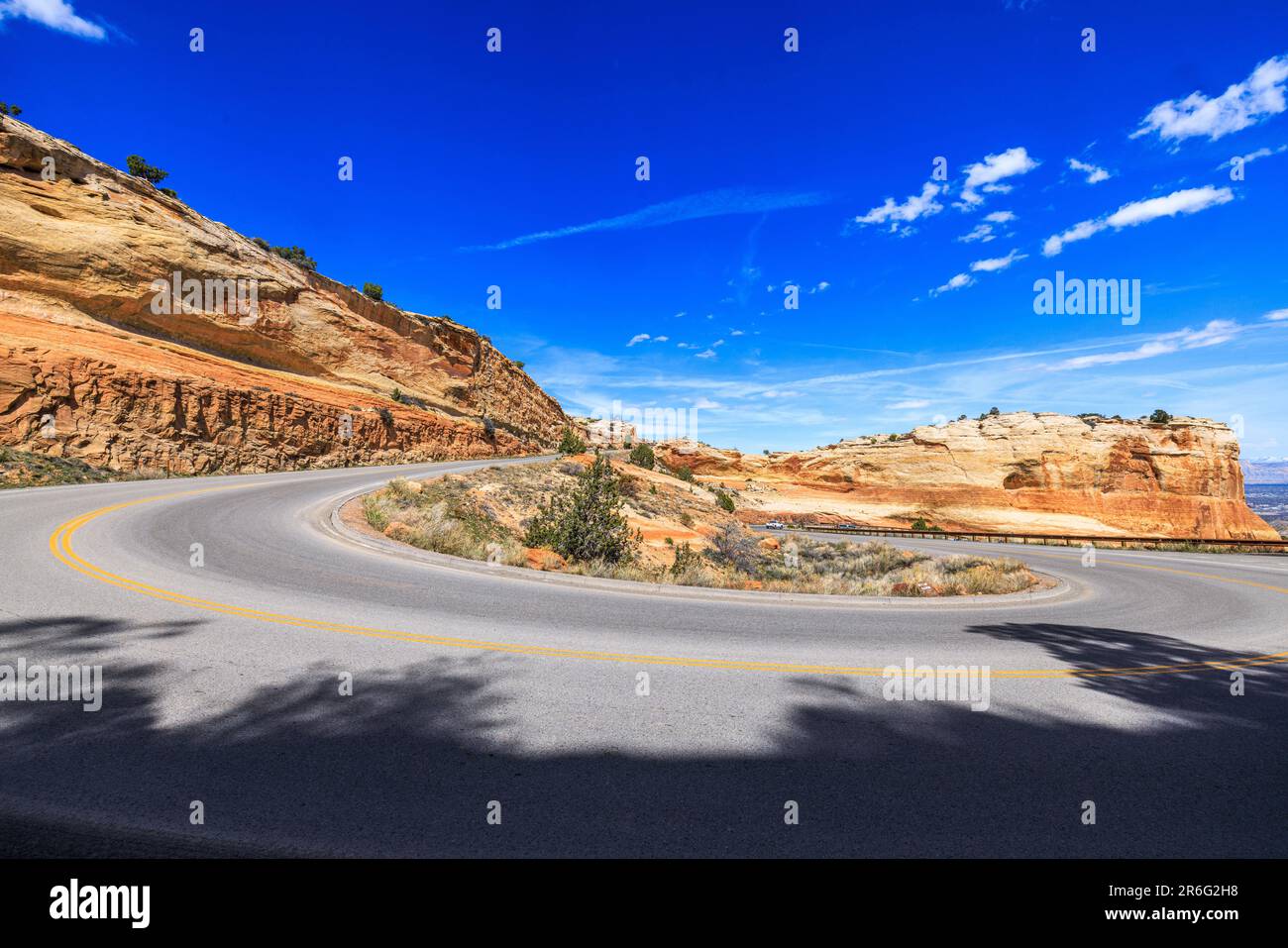 This stunning image shows a long, curved road winding its way down a ...