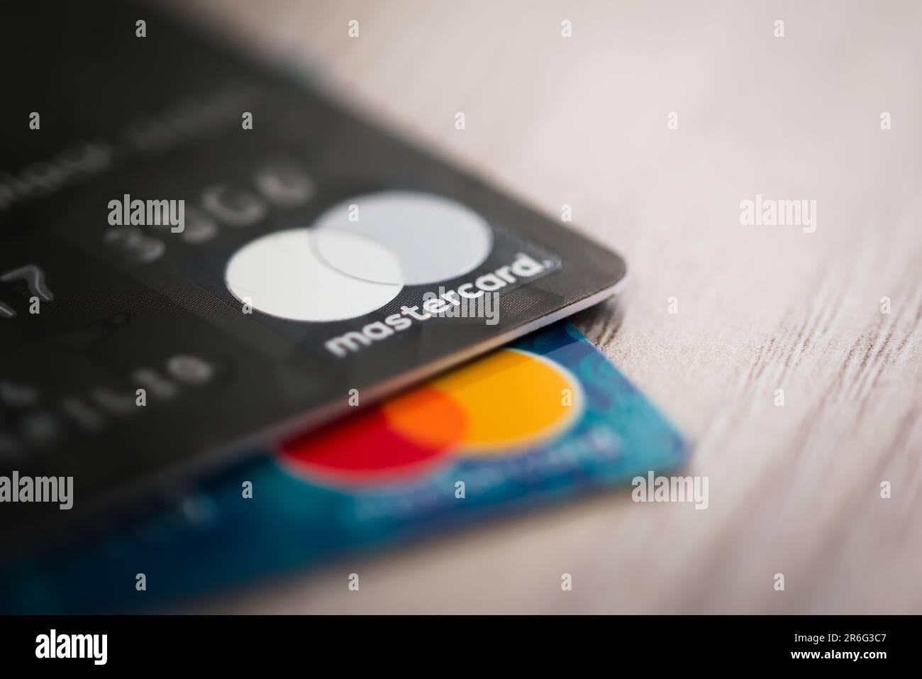 Mastercard logo printed in silver on a black debit card. Close up ...