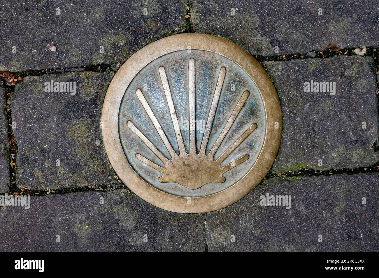 Scallop shell on metal plate on brick floor on Camino de Santiago ...