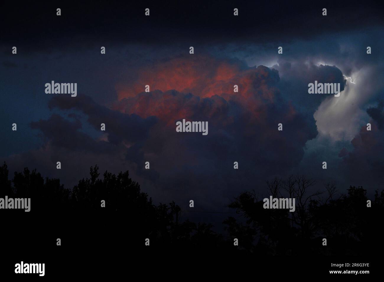 Intense red storm cloud with lightning strike. Red cumulonimbus cloud ...