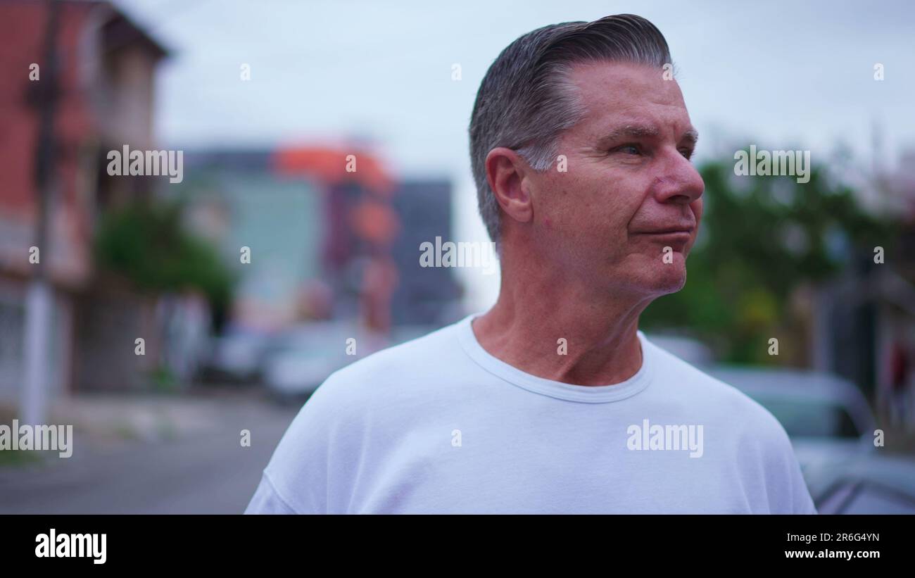 Happy senior man walking in street in daylight. A smiling middle-age ...