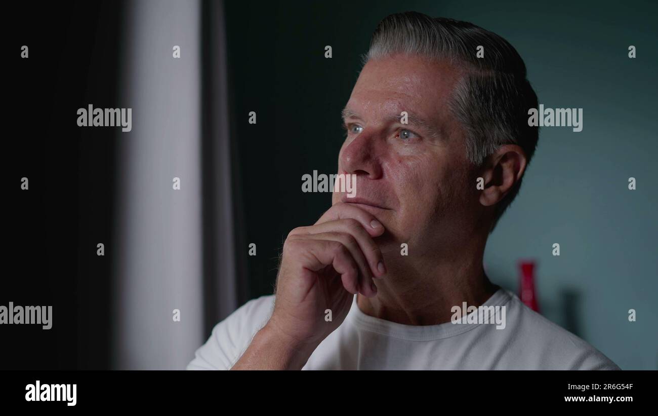 Middle-Aged Man with Gray Hair Gazing Out Window with hand in chin ...