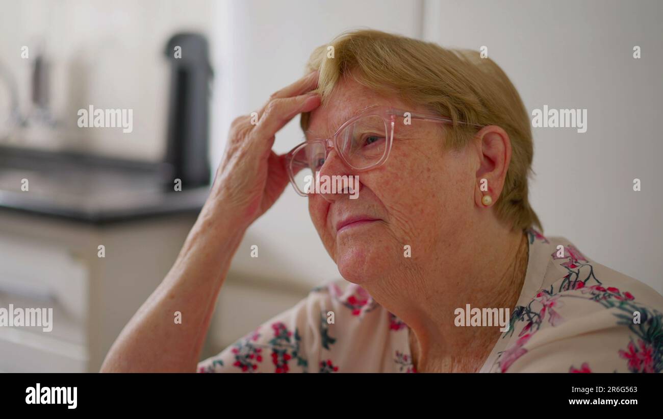 Pensive Close-Up of Senior Woman s Face, Hand on Forehead, Reflecting ...