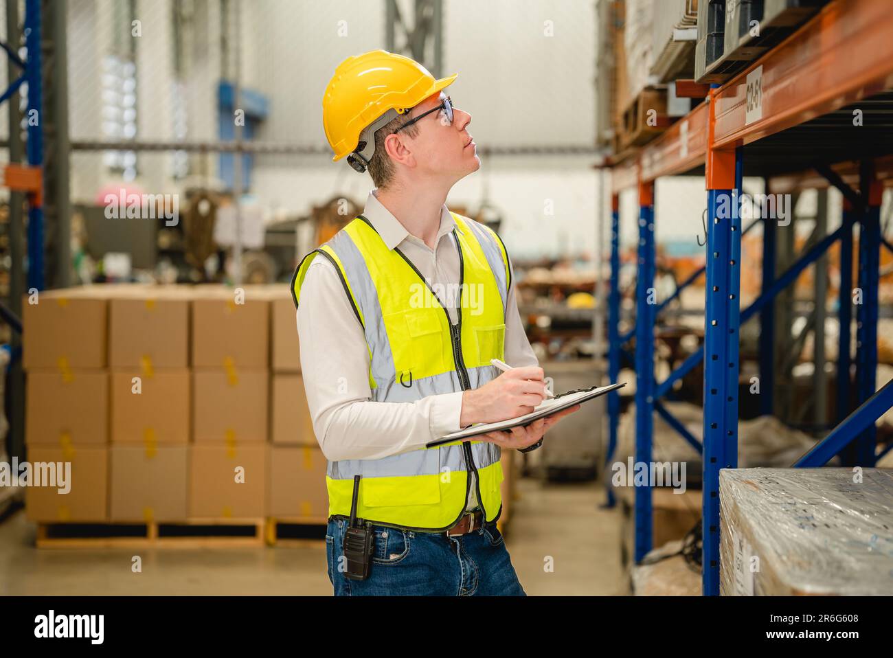 Warehouse workers talking together checking goods in storage Stock ...