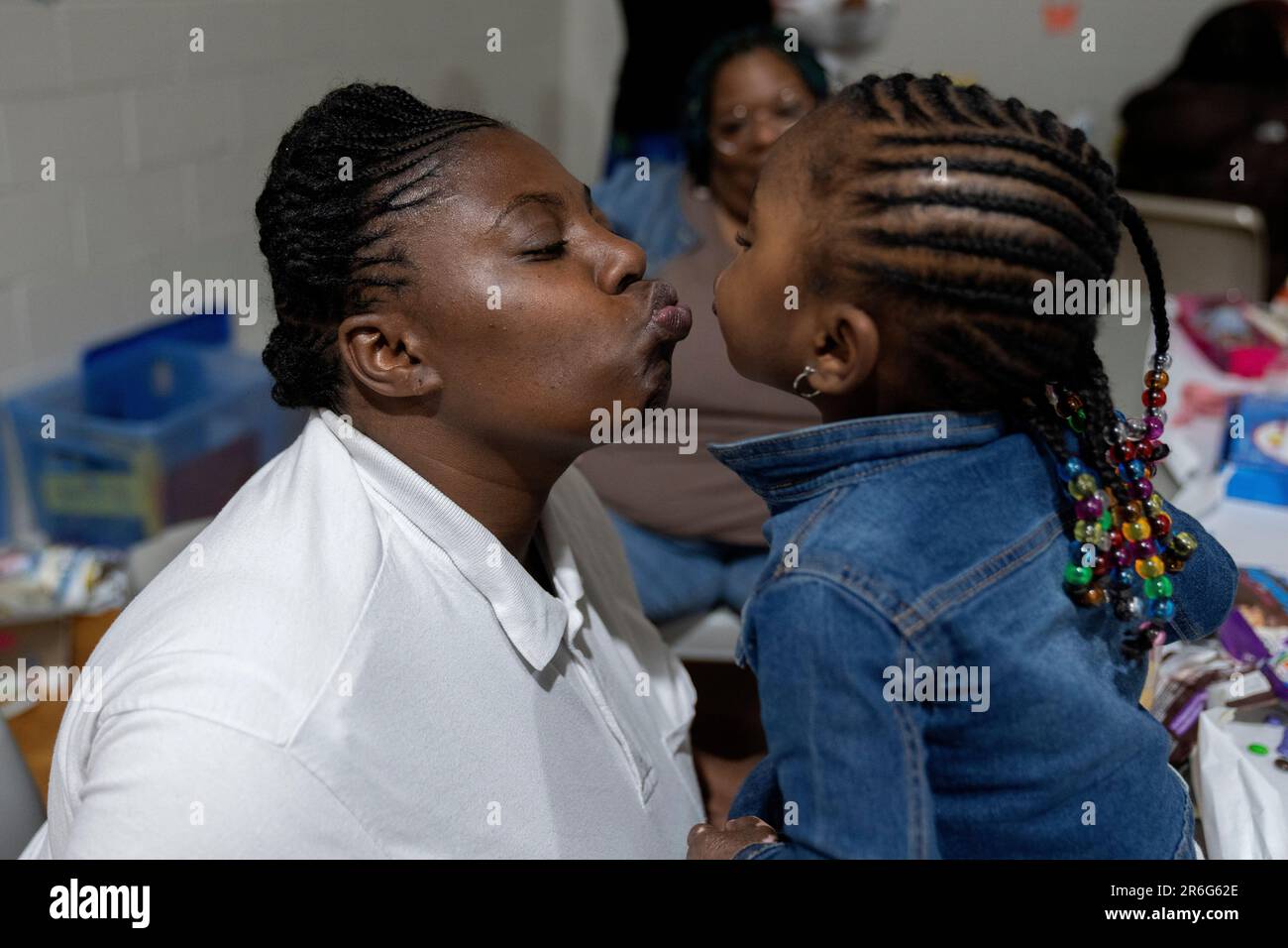 Joshlyn Allen kisses her 3-year-old daughter Journey Miller during a ...