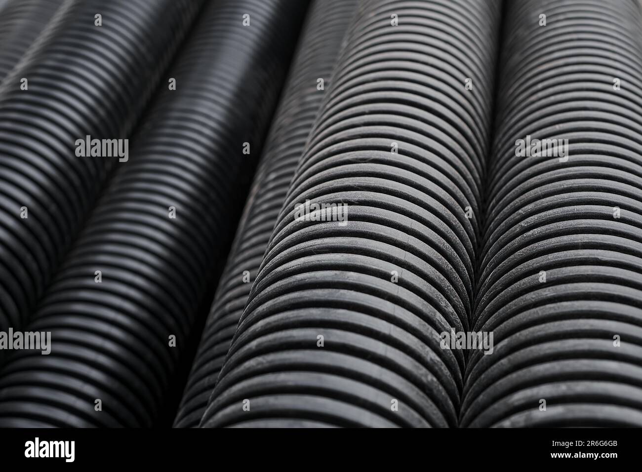 Black building pipes, selective focus, coated corrugated pipes for road ...
