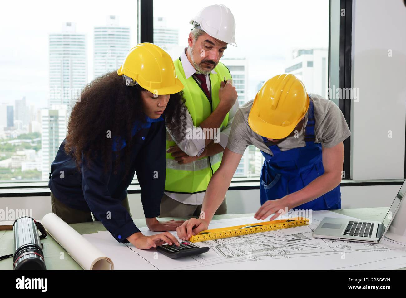 Construction engineers team using blueprint of project plan Stock Photo ...