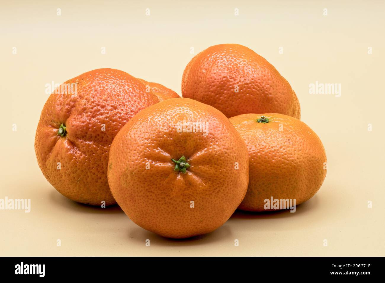 A pile of mandarins on beige background Stock Photo - Alamy