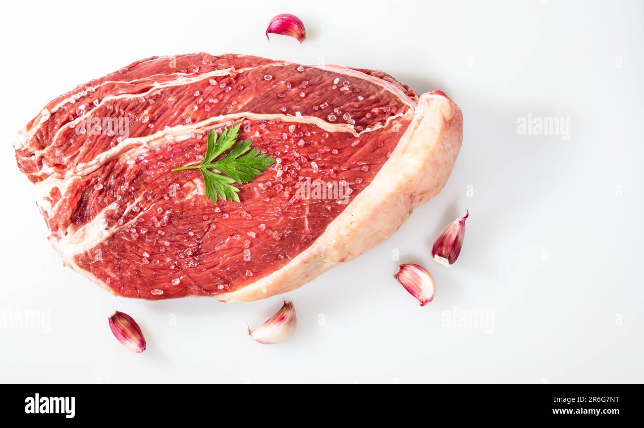 A top view of a raw red steak with salt on a white background Stock ...