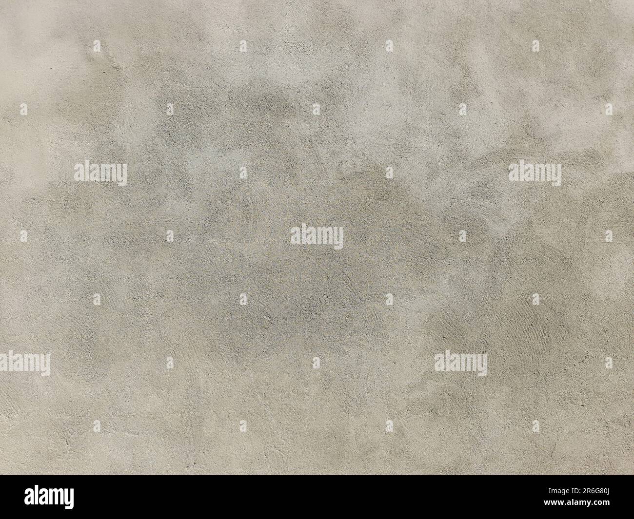 A large cement floor with white trim around the perimeter and several ...