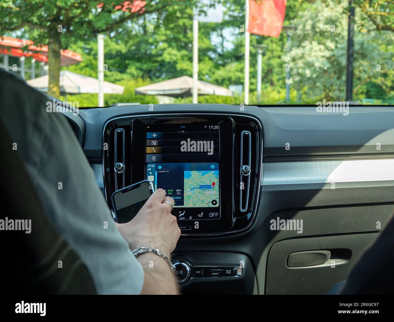 A young man uses a navigator in the car. Modern technology in the car ...