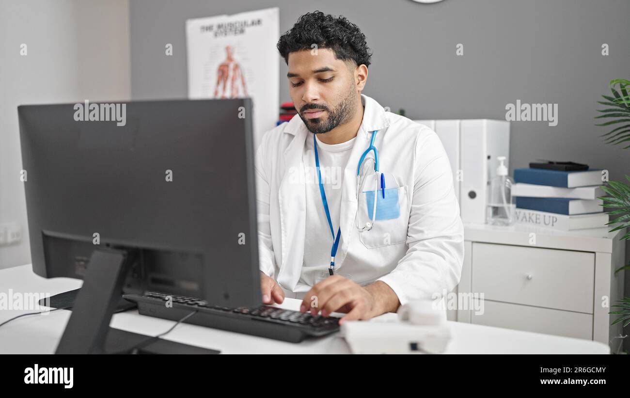 African american man doctor using computer working at clinic Stock ... African american man doctor using computer working at clinic Stock ...