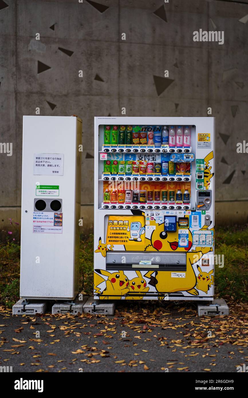 Two vending machines stand side by side in a grassy outdoor setting ...