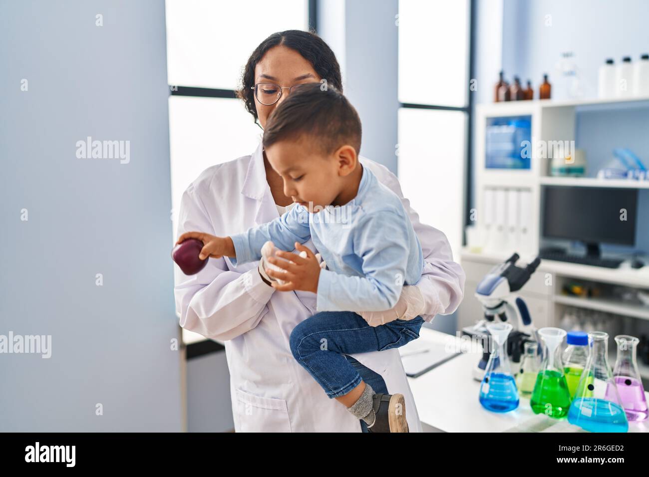 Mother and son wearing scientist uniform hugging each other at ...