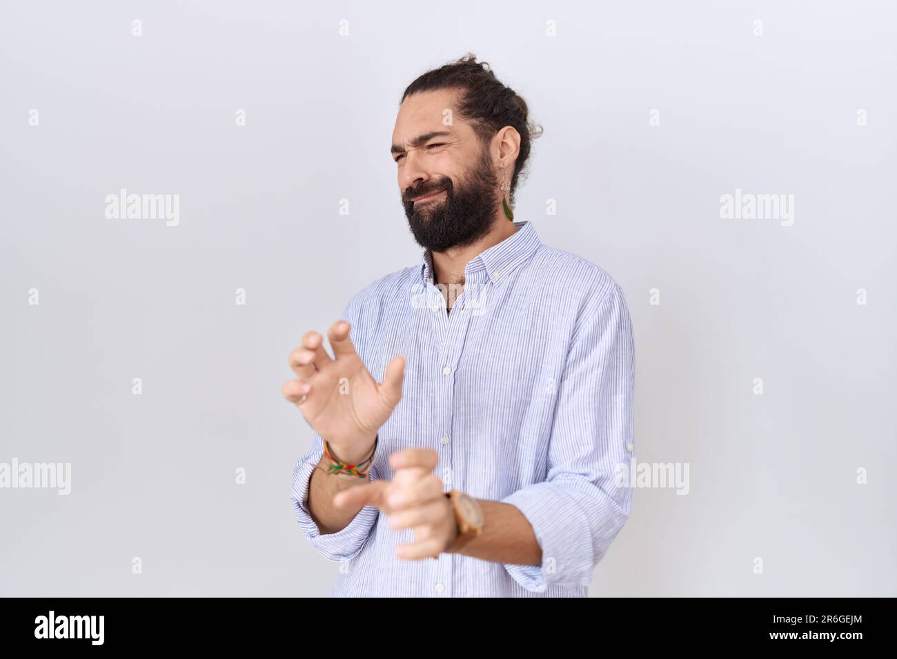 Hispanic man with beard wearing casual shirt disgusted expression ...