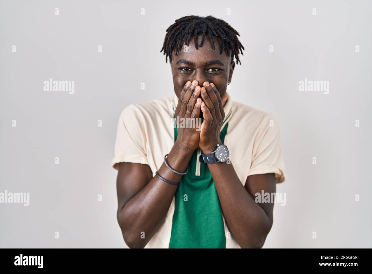 African man with dreadlocks standing over isolated background laughing ...