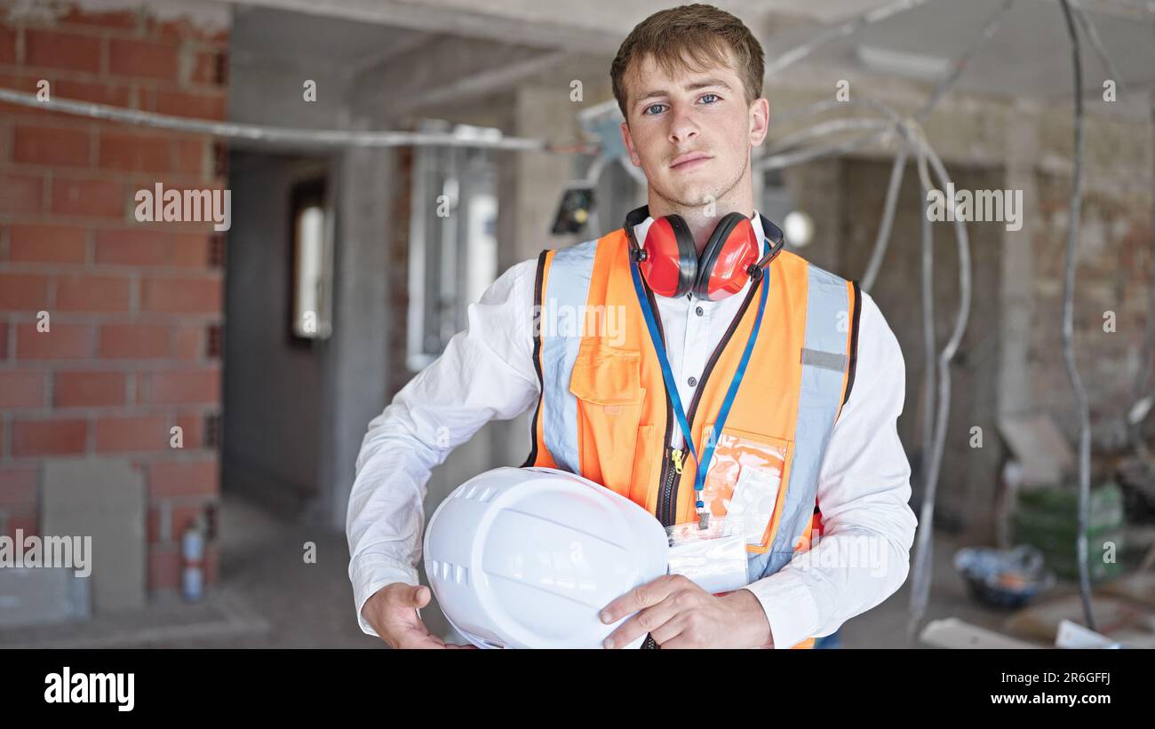Young caucasian man architect standing with relaxed expression holding ...
