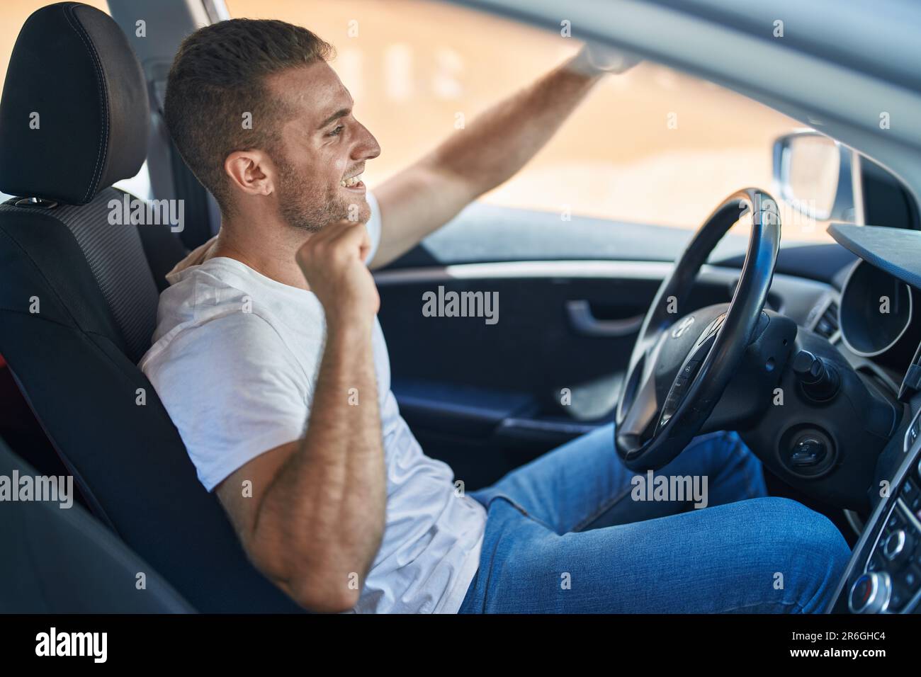 Man driving car dancing listening hi-res stock photography and images ...