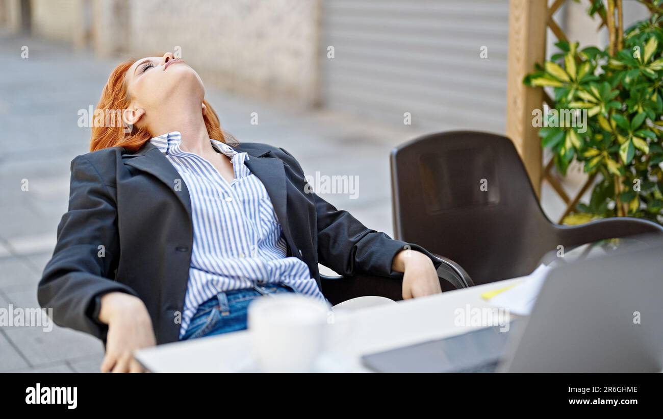 Young Redhead Woman Business Worker Finishing To Work Relaxed At Coffee