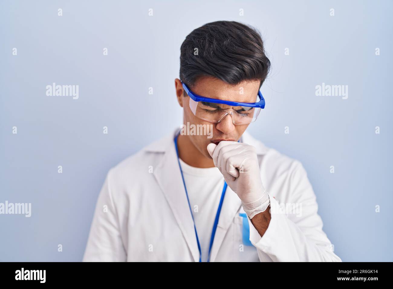 Hispanic man working as scientist feeling unwell and coughing as ...